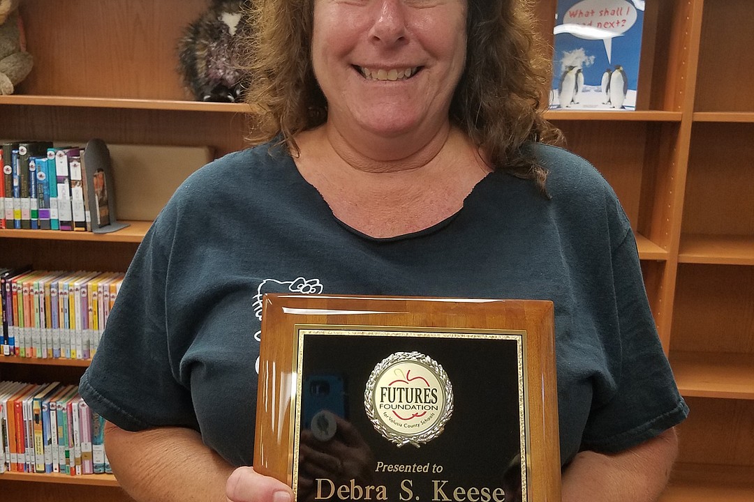 Debra Keese, registrar at Cypress Creek Elementary School, receives ...