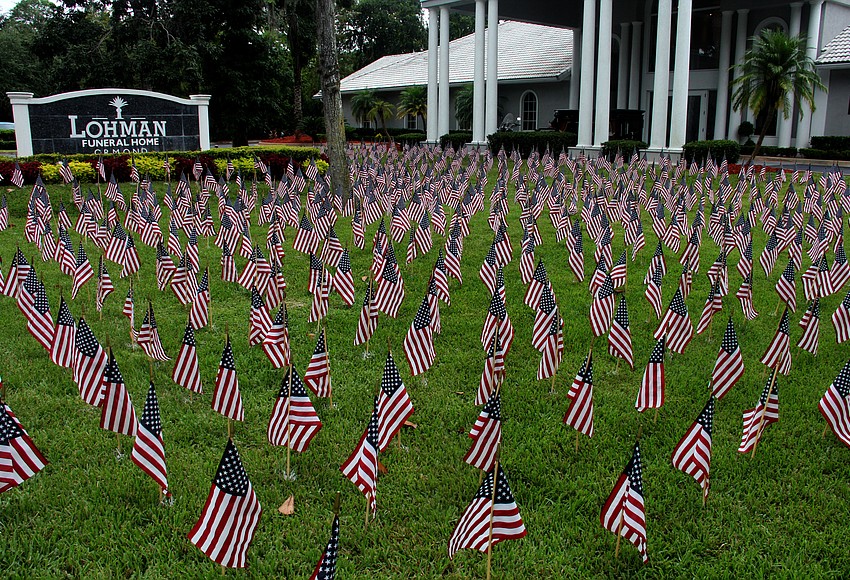 Volunteers place American Flags for 9/11 at Lohman’s Funeral Home ...