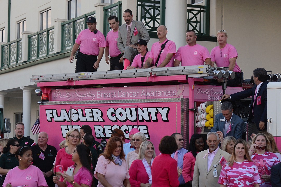 Officials, residents raise Pink Army flag for breast cancer awareness ...