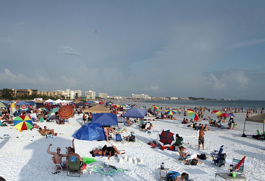 Your Observer | Photo - Thousands of people set up umbrellas, tents and ...
