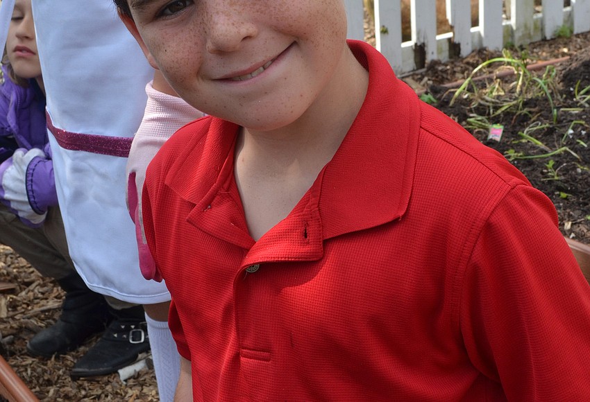 Your Observer | Photo - Aiden Pearson spends his recess working on the salsa garden.