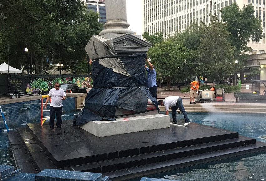 Jax Daily Record| Photo - Workers place a tarp over the statue. (Photo ...