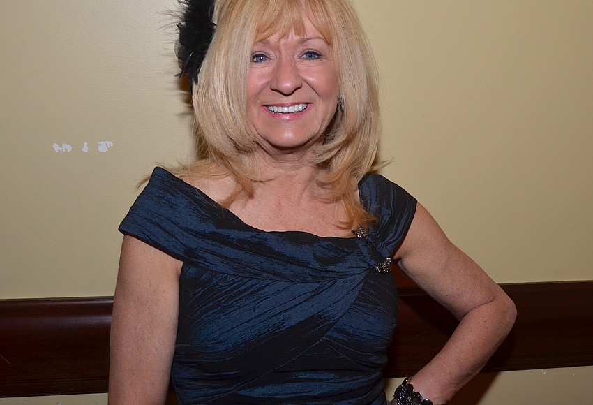 Your Observer | Photo - Carol Busse chats with friends before dinner.