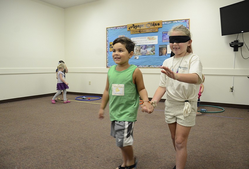Your Observer | Photo - Ezra DeJesus guides Brielle Baker for a game.