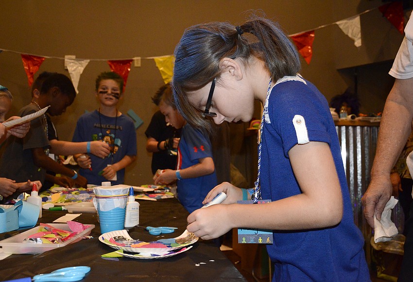 Your Observer | Photo - Audrey Roden finishes up her paper fish.