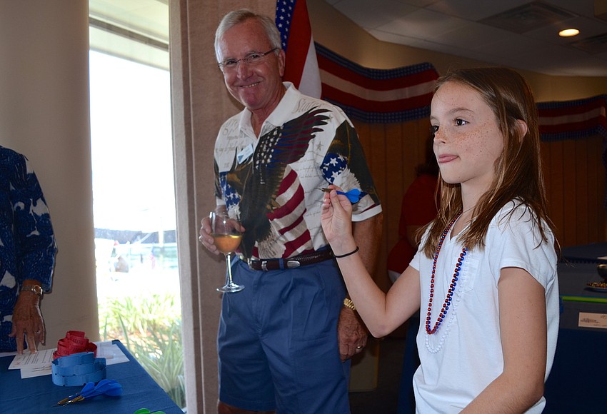 Your Observer | Photo - Caroline Bell, 11, throws a dart at red and ...