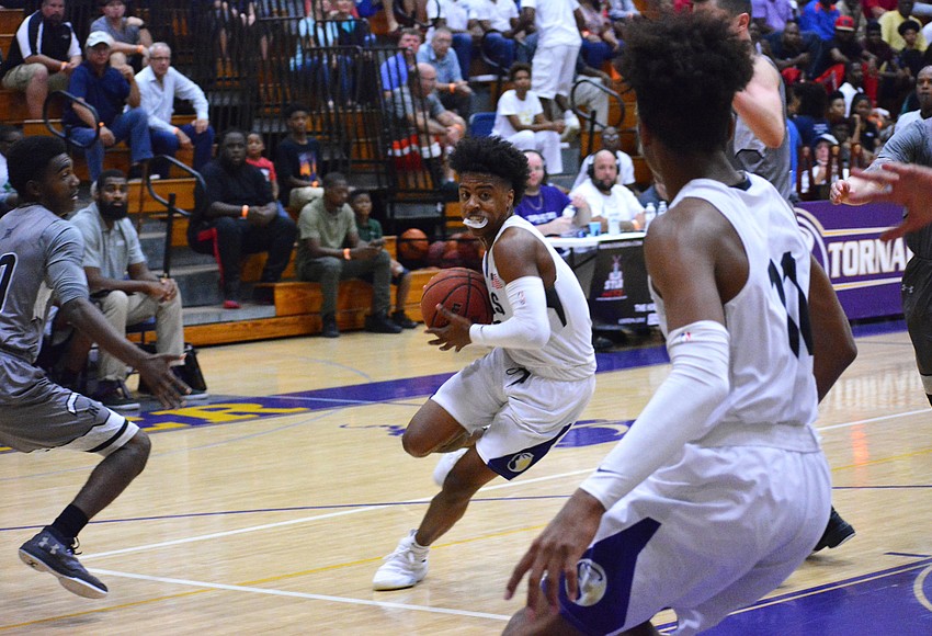 Your Observer | Photo - Jaylen Jones splits two defenders and heads ...