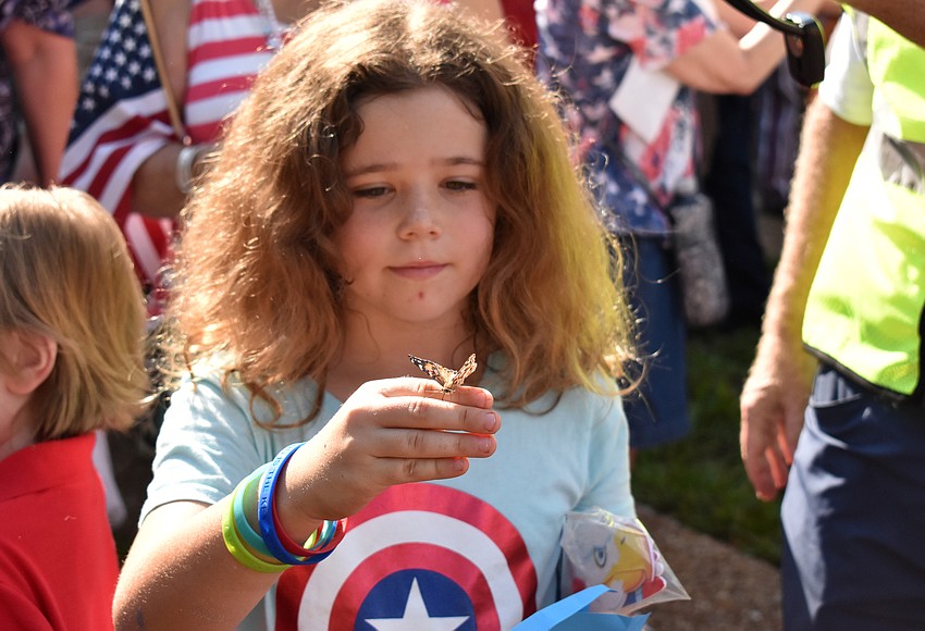 Your Observer | Photo - Leilah Miller releases a butterfly.