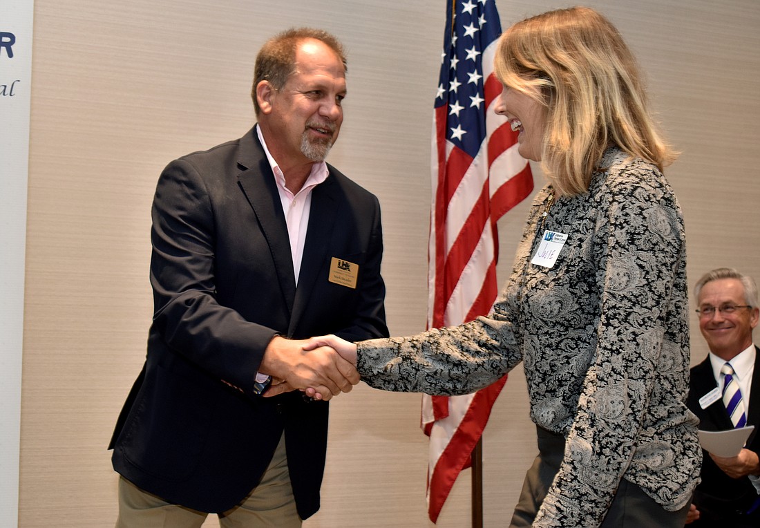 Your Observer | Photo - Mark Meador shakes Julie Kirkwood’s hand after ...