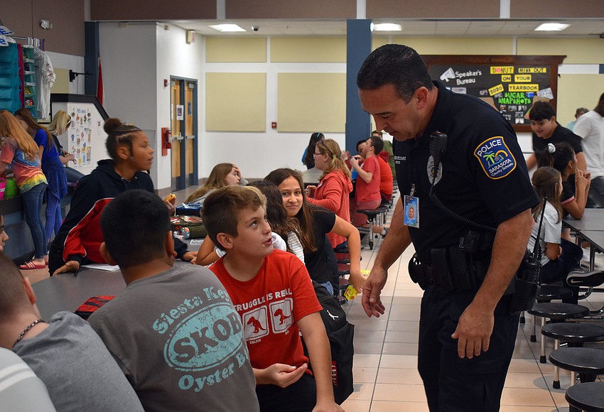 Your Observer | Photo - Officer Anthony Limite bends down to talk to ...