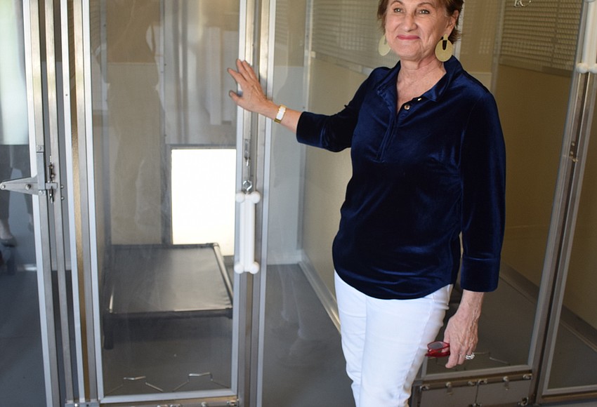 Your Observer | Photo - Susan Giroux shows off one of the kennels.