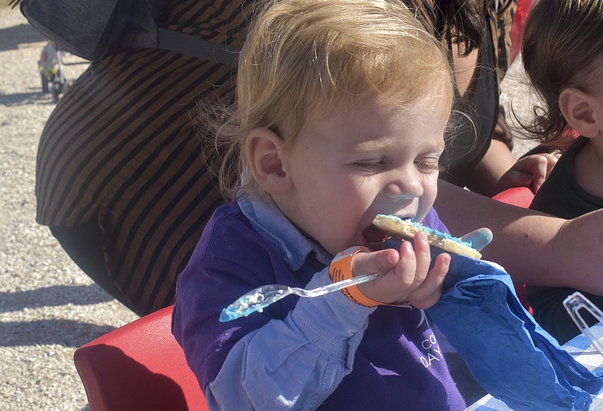 Your Observer | Photo - Sterling Saiger, 2, tastes the cookie he decorated.