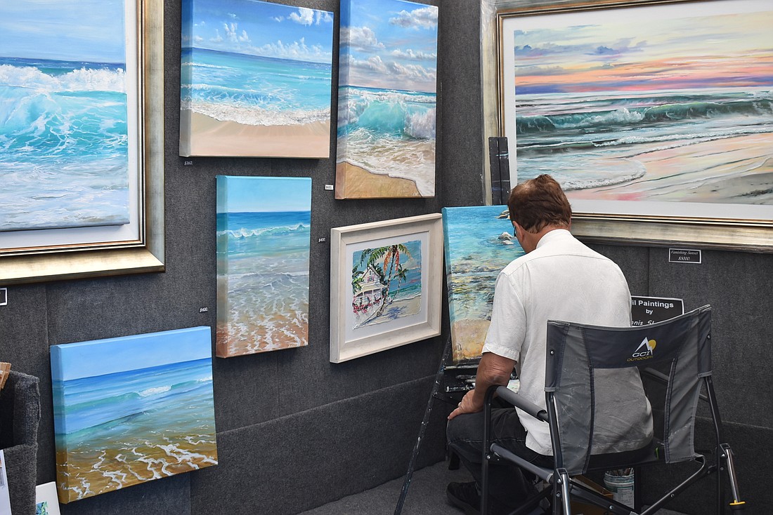 Your Observer | Photo - Dennis Shattuck works on another piece in his tent.