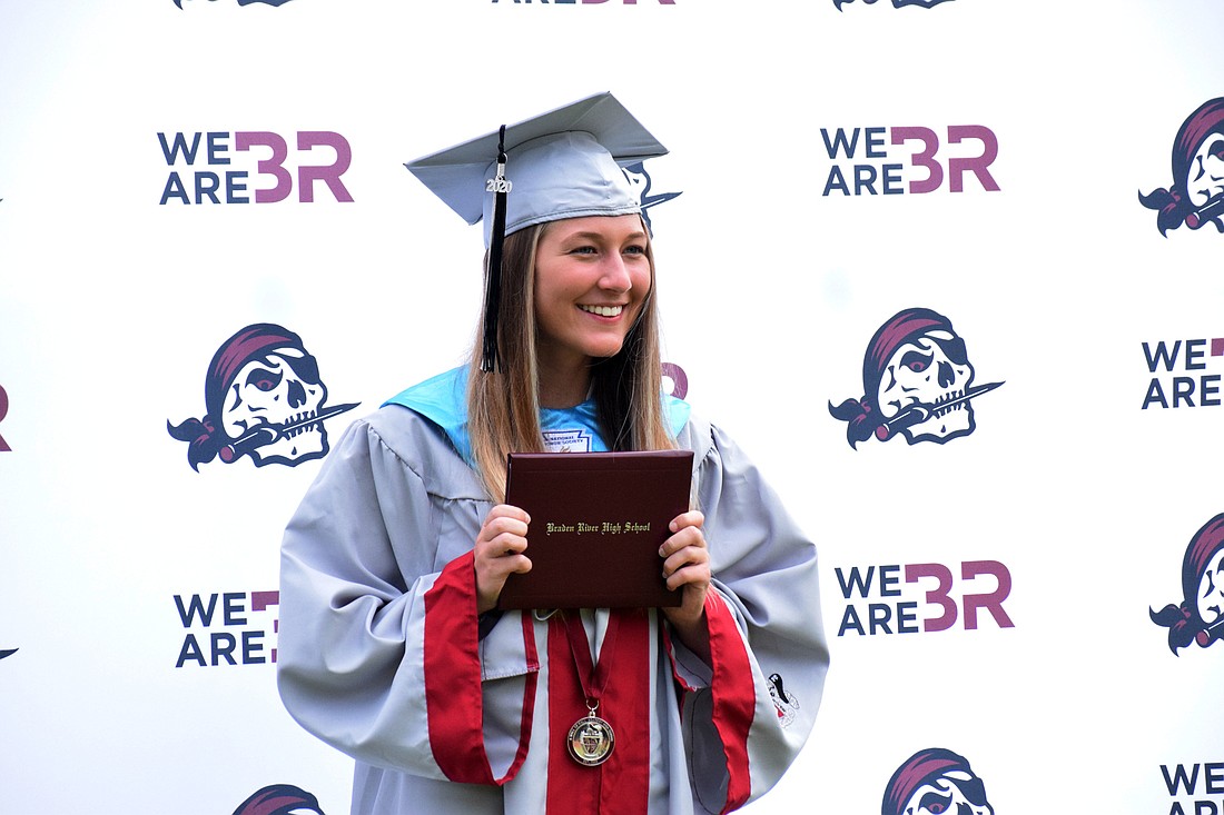 Your Observer | Photo - Sydney Brummett shows off her diploma.