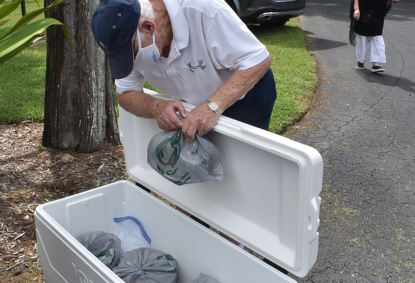 Your Observer | Photo - Lewis Moyer organizes meals, which are kept ...