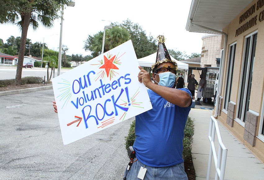 Your Observer | Photo - Jose Guerro held up a sign for oncoming drivers.