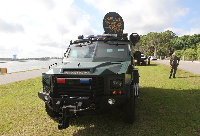 Your Observer | Photo - Families look at the BearCat SWAT car.