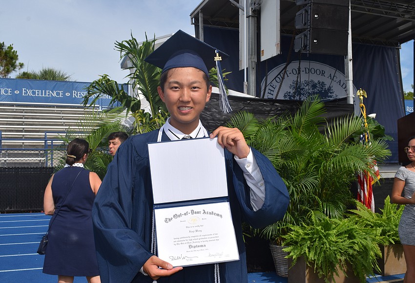 Your Observer | Photo - Graduate Arthur Wang shows off his diploma.