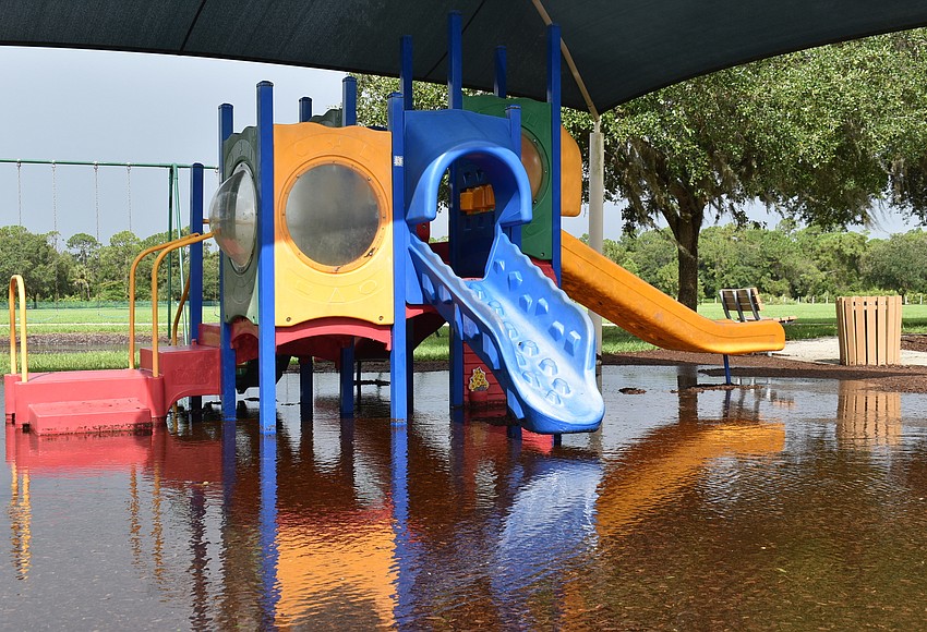 Your Observer | Photo - Water pools underneath the playground Wednesday ...