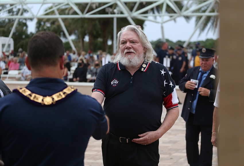 Your Observer | Photo - Richard Bouchard accepts a commemorative coin.