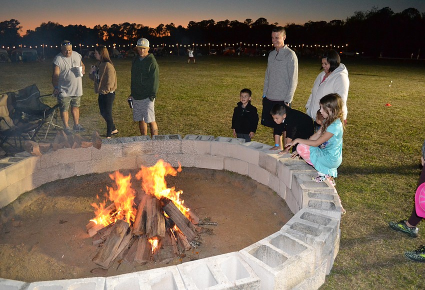 Your Observer | Photo - Families gather around the campfire.