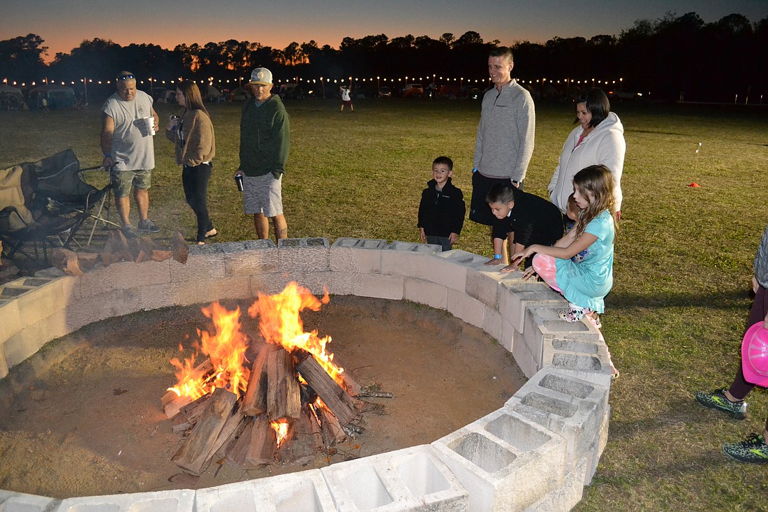 Your Observer | Photo - Families gather around the campfire.