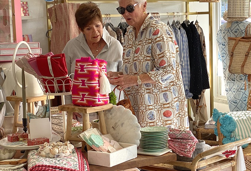 Your Observer | Photo - Karen Talty and Pat Dupps shop during the party.