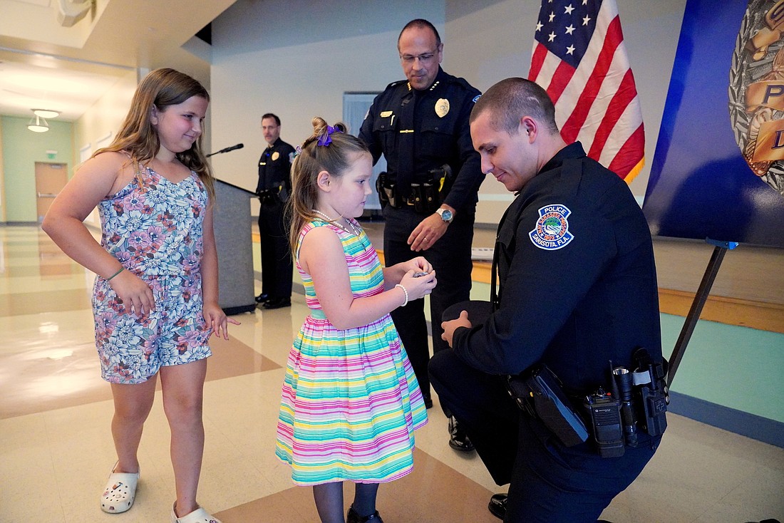 Photo: New SPD Officer Thomas Wishart is pinned by his daughters ...